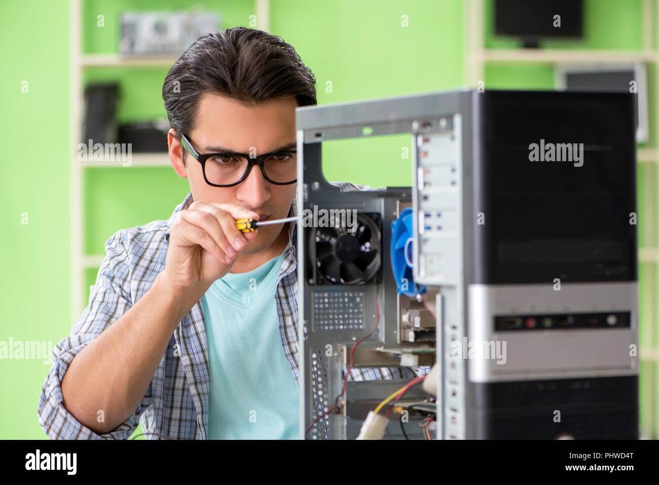 Computer engineer repairing broken desktop Stock Photo - Alamy