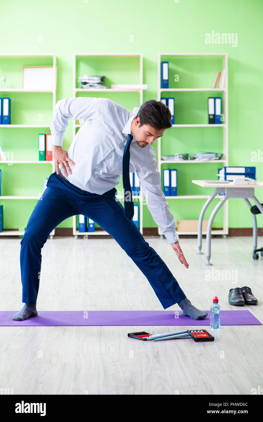 Employee doing exercises during break at work Stock Photo - Alamy