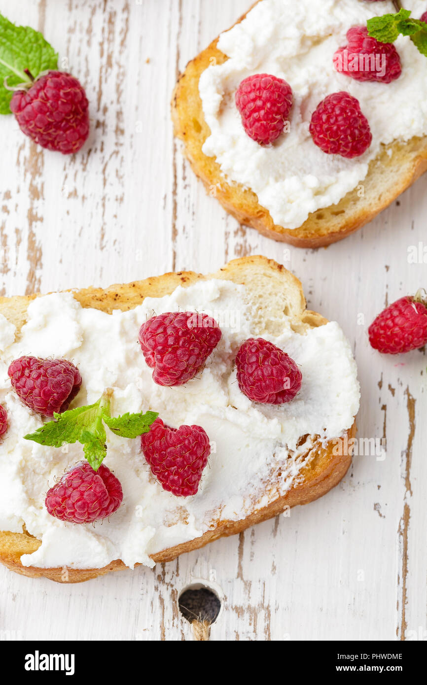 Breakfast slice of bread with Ricotta cheese served with raspberries ...