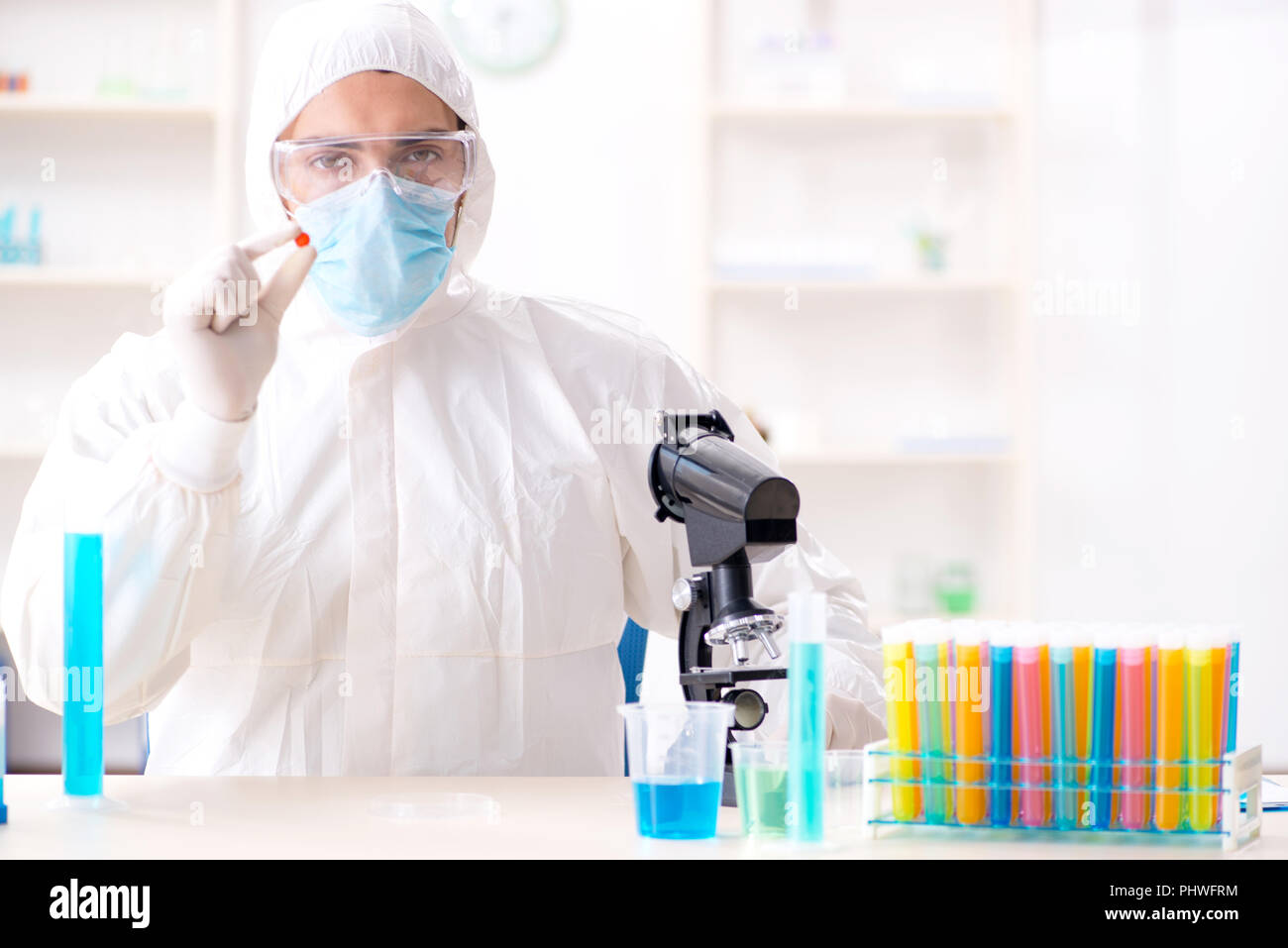 Lab assistant in drug synthesis concept Stock Photo - Alamy