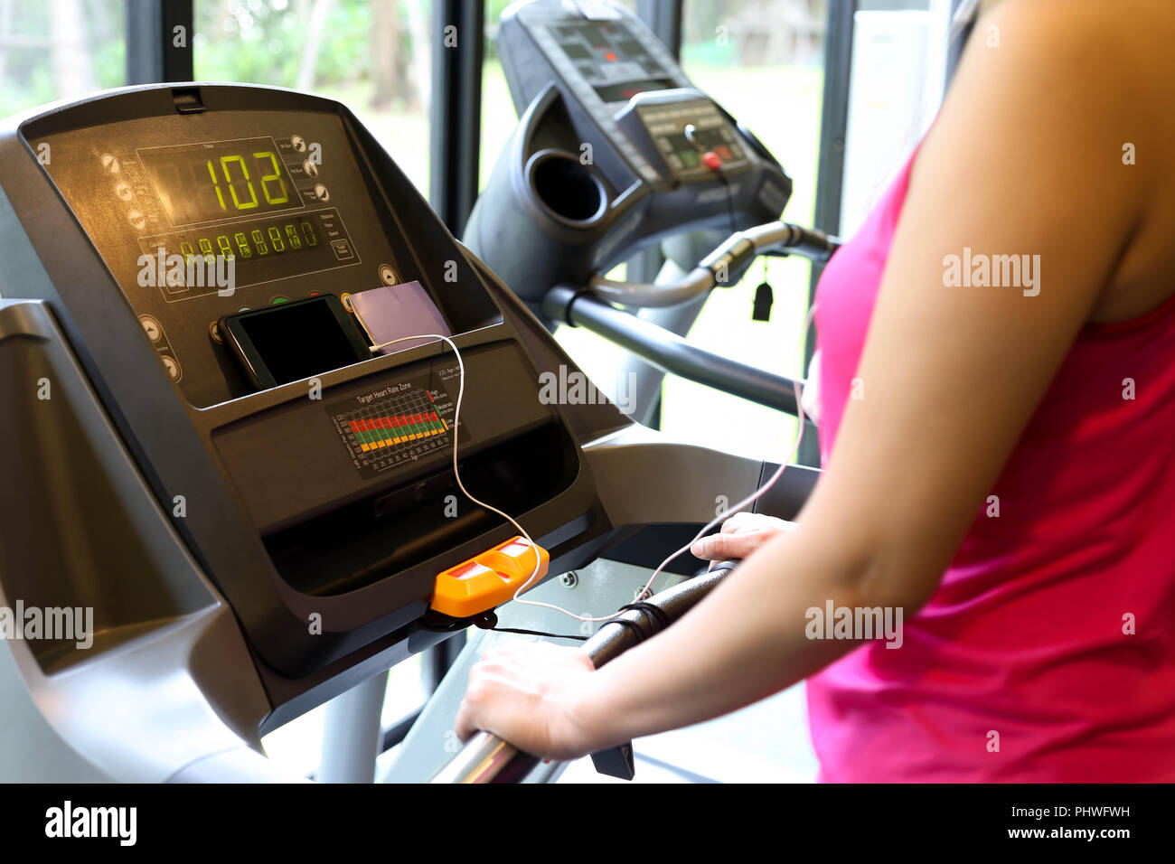 Woman exercise on the running machine at the gym Stock Photo - Alamy