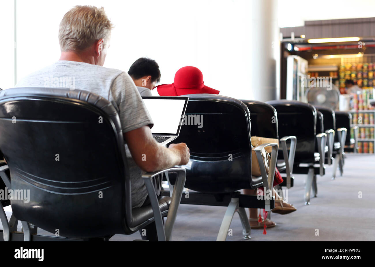 Passenger at the airport using his tablet computer Stock Photo - Alamy