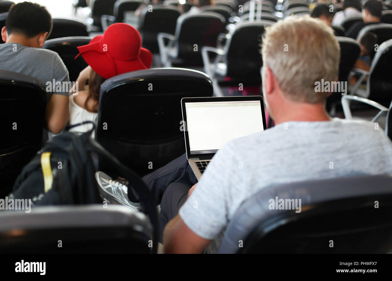 Businessman using laptop airport departure hi-res stock photography and ...