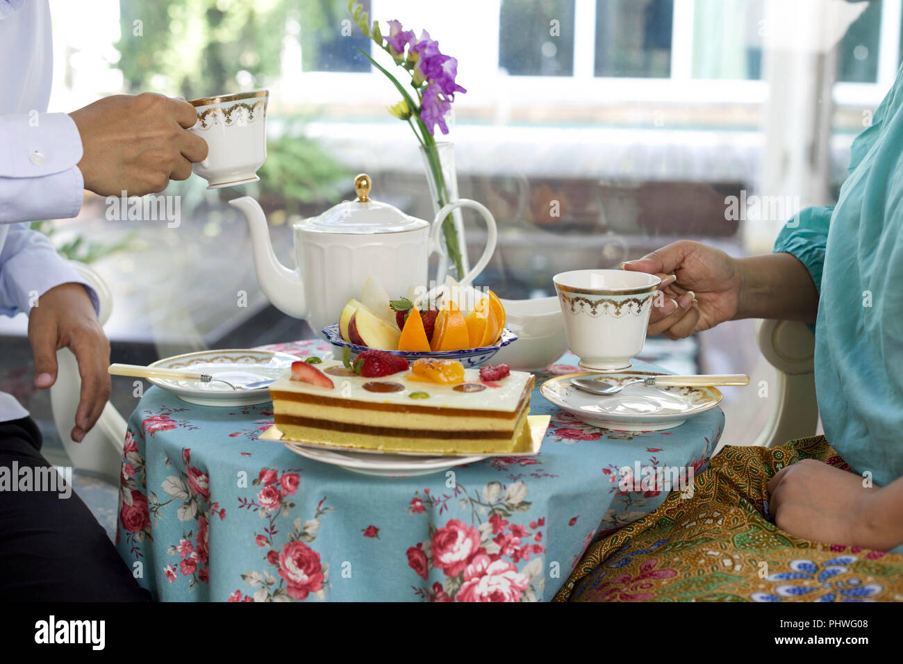Asian business people having tea and cake and fresh fruit Stock Photo ...