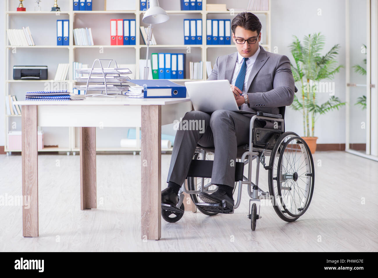 Disabled businessman working in the office Stock Photo - Alamy