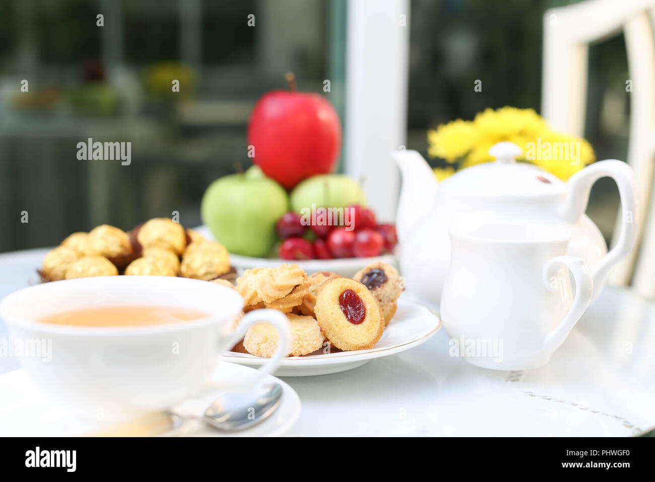 Tea time with chocolate and cookies or biscuit and fruit Stock Photo ...