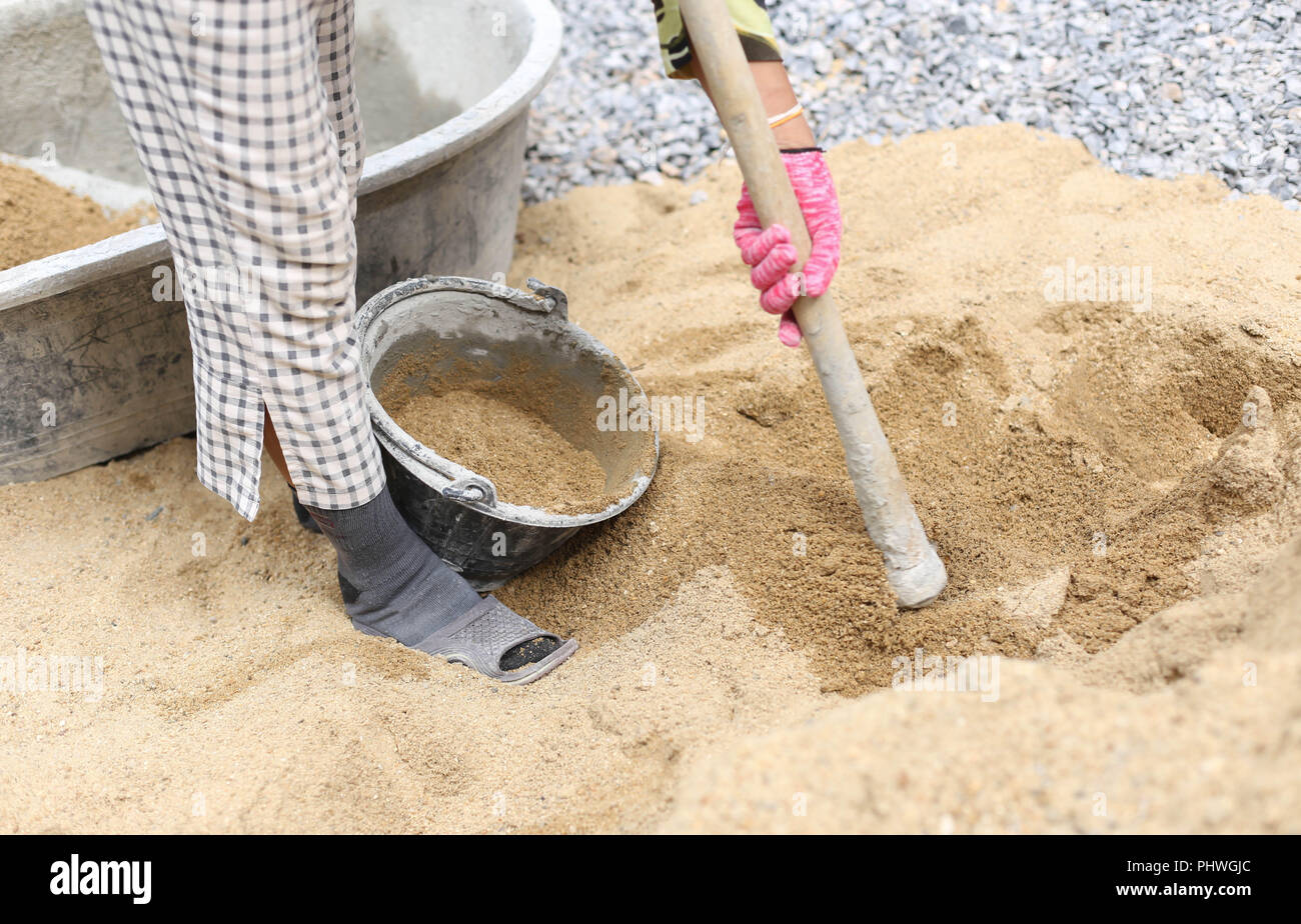 Construction workers are putting sand in the sand bucket Stock Photo ...