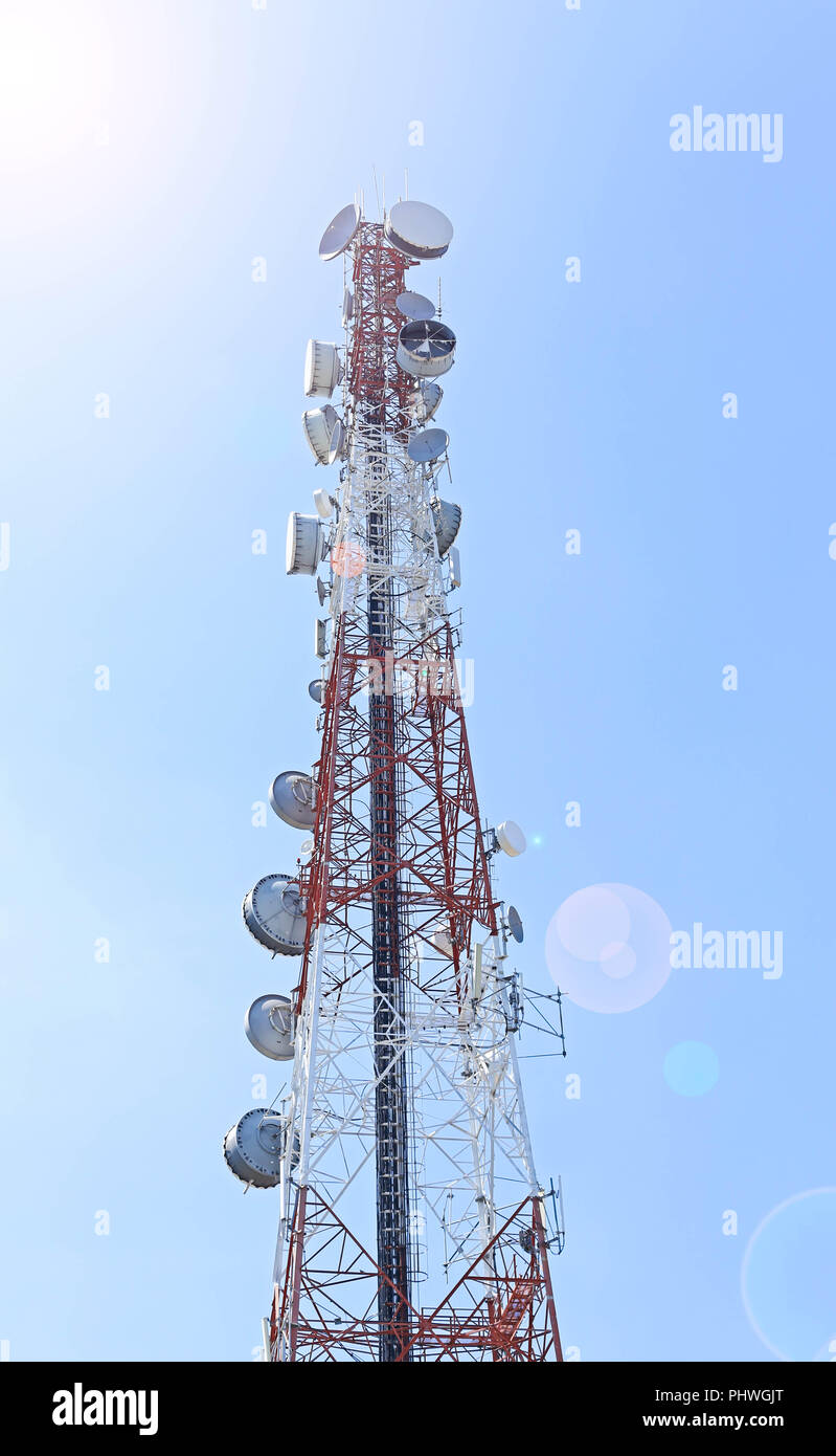 Telecommunication post on blue sky with lens Flare Stock Photo - Alamy
