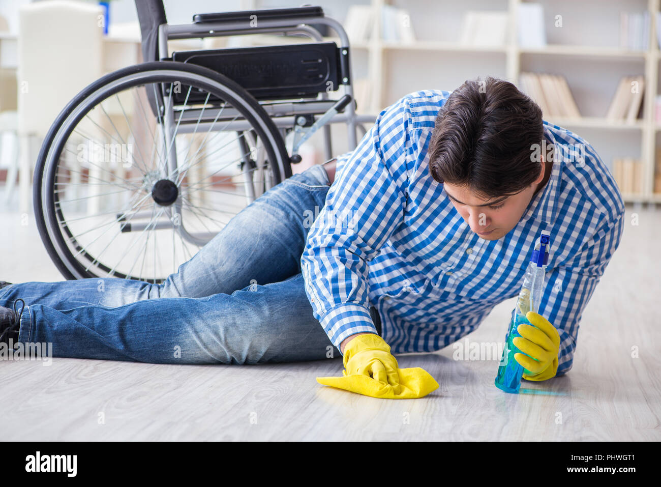 Disabled man on wheelchair cleaning home Stock Photo - Alamy