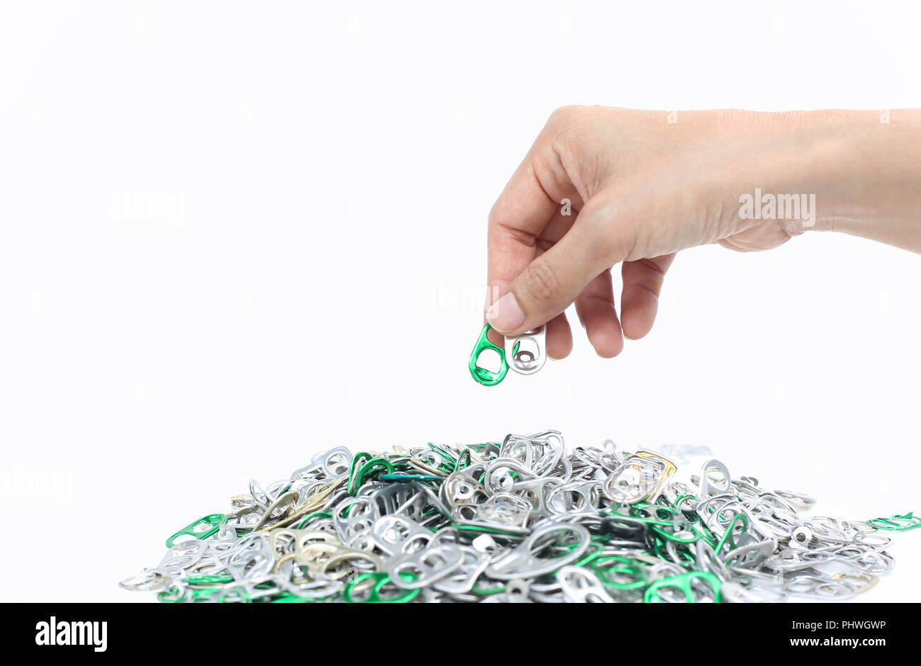 Hand holding aluminum cap can over a pile of cap can Stock Photo - Alamy
