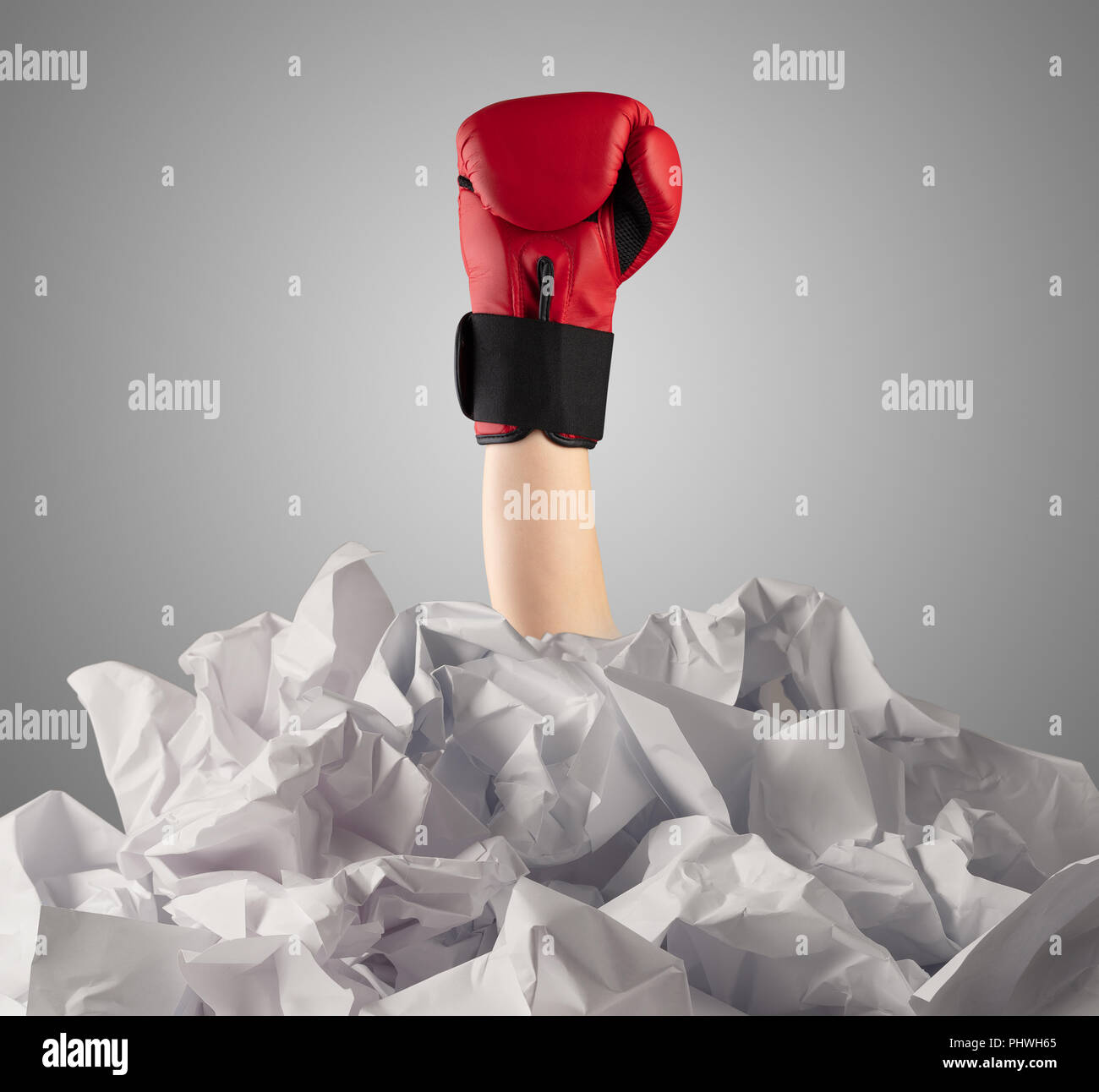 Hand breaking out from pile of paper Stock Photo - Alamy