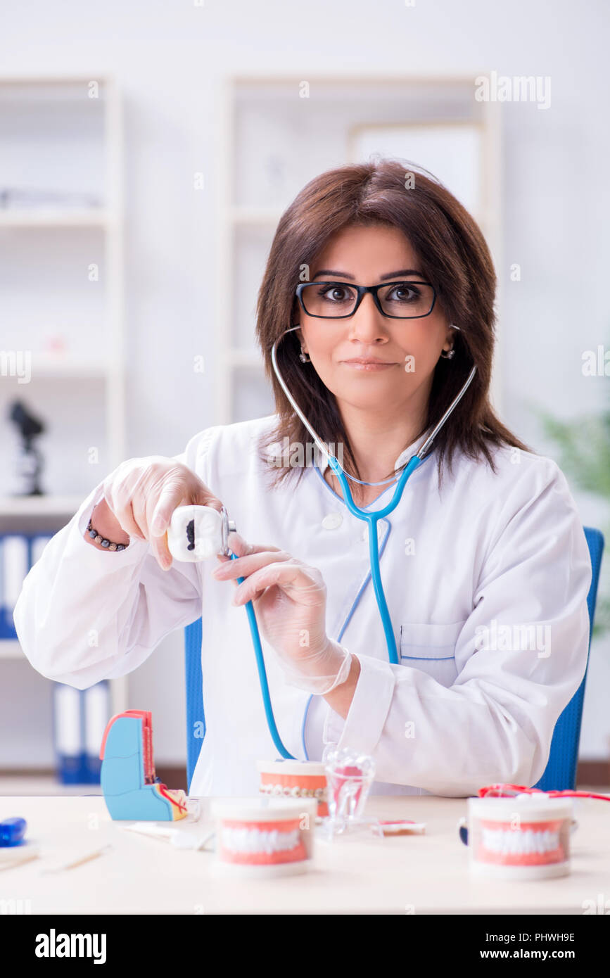 Woman dentist working on teeth implant Stock Photo - Alamy