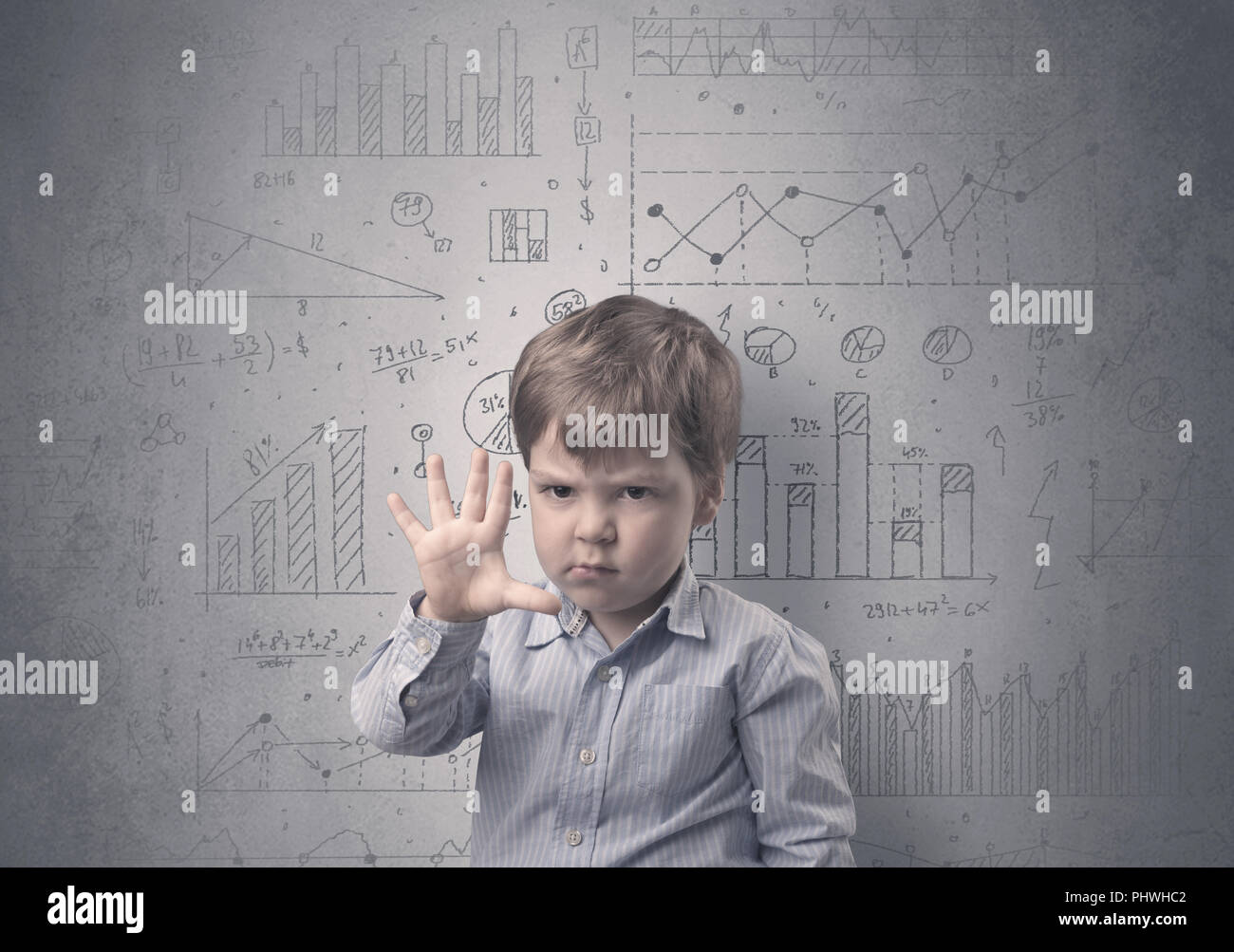 Little boy in front of a grey wall with graphs and statistics around ...