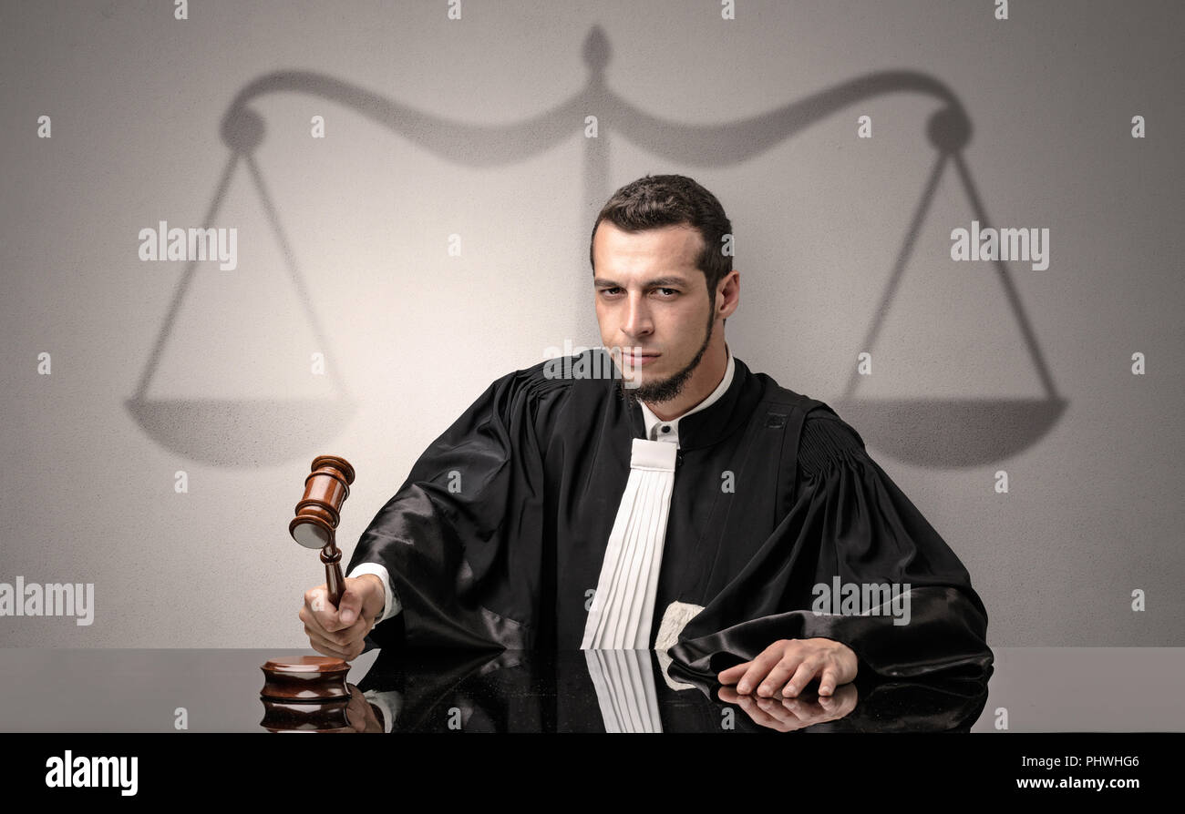 Young handsome judge in black gown making decision Stock Photo - Alamy