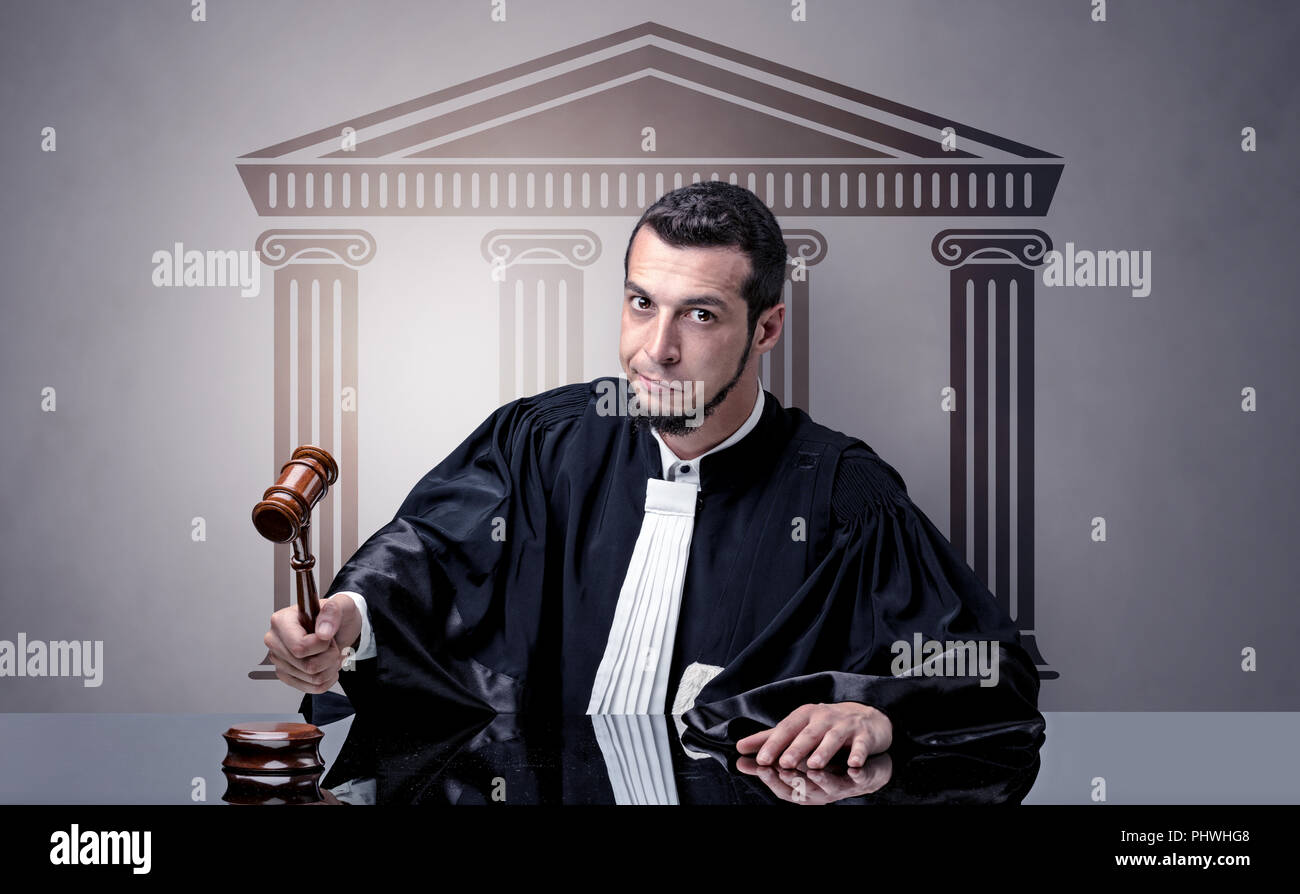 Young judge in front of a courthouse symbol making decision Stock Photo ...