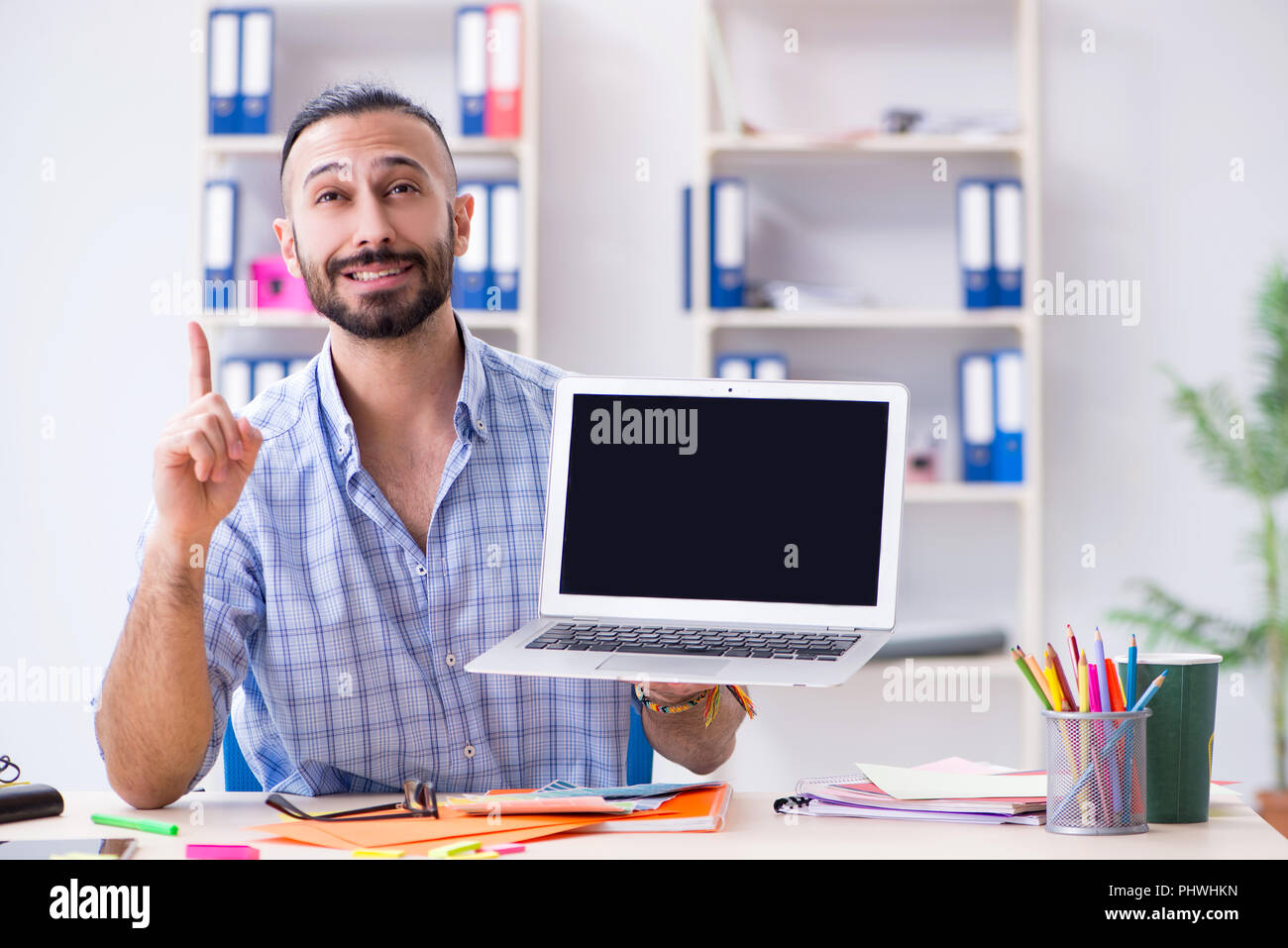 Young designer working in his studio on new project Stock Photo - Alamy