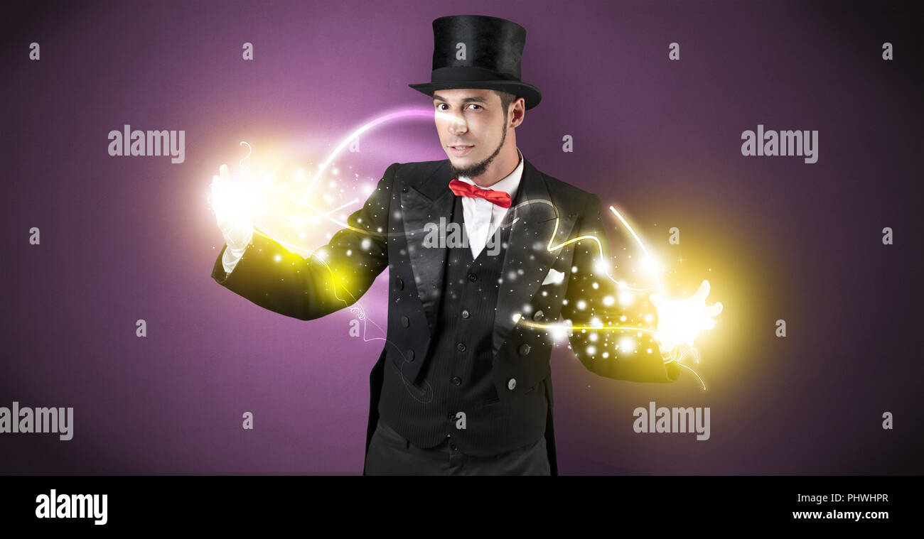 Magician holding his sparkling power between his two hand Stock Photo ...