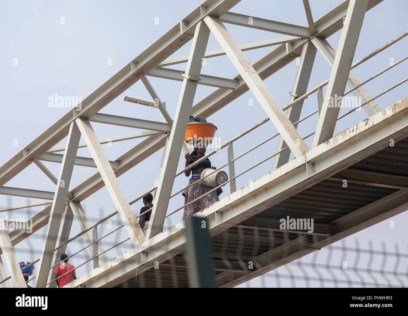 Angolan people crossing ametal bridge, Luanda Province, Luanda, Angola ...