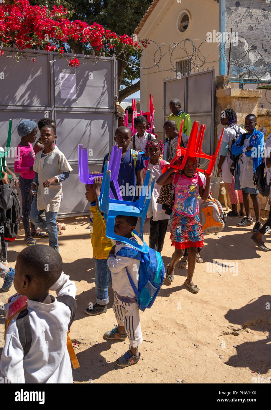 Angolan children carrying her own chairs to go to school, Huila ...