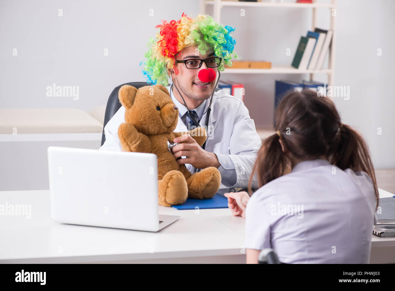 Funny pediatrician with little girl at regular check-up Stock Photo - Alamy