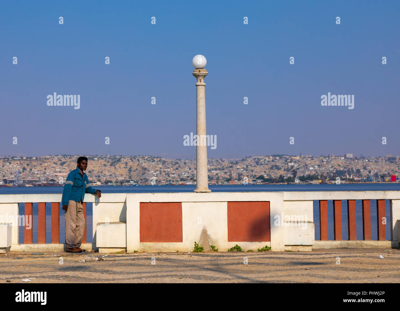 Angolan man leaning on fence, Benguela Province, Lobito, Angola Stock ...