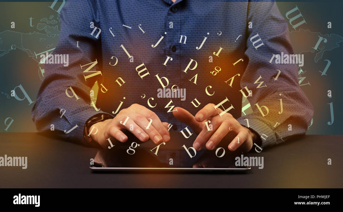 Young man in suit and formal clothing typing with letters around Stock ...