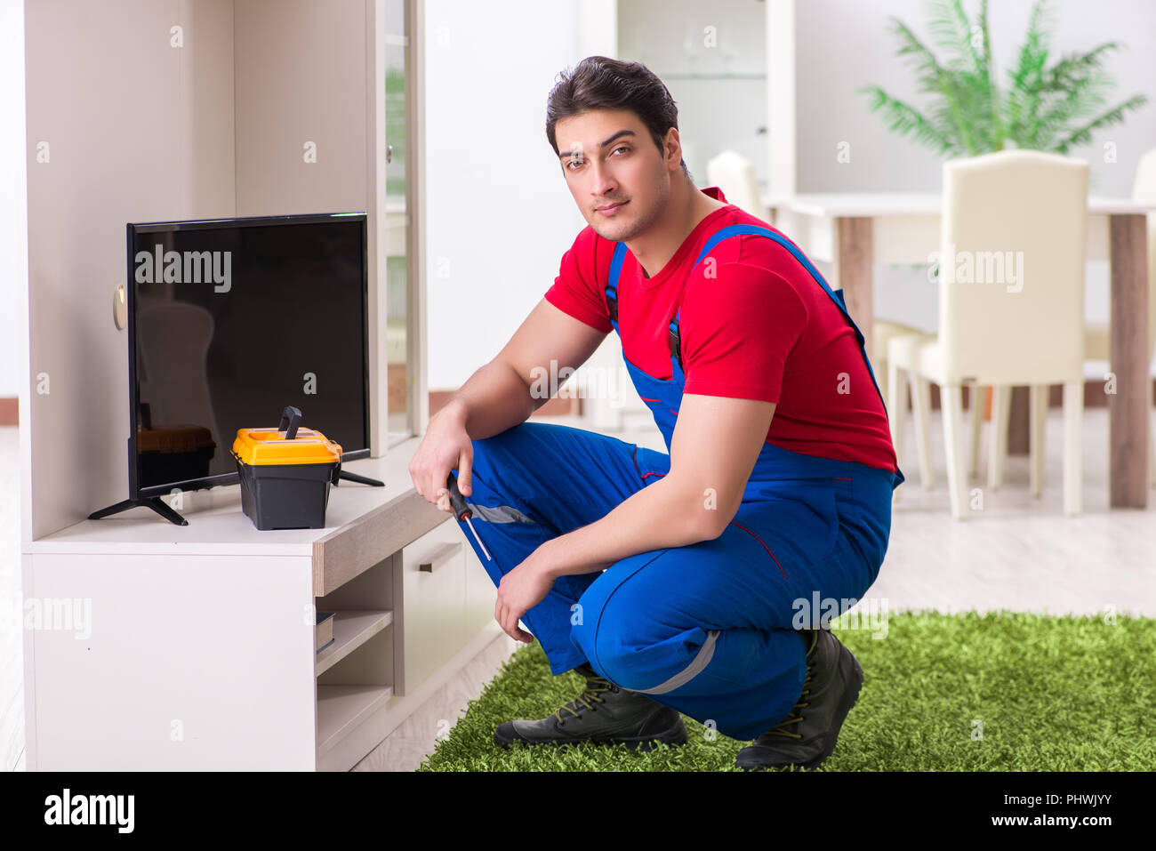 Professional repair engineer repairing broken tv Stock Photo - Alamy