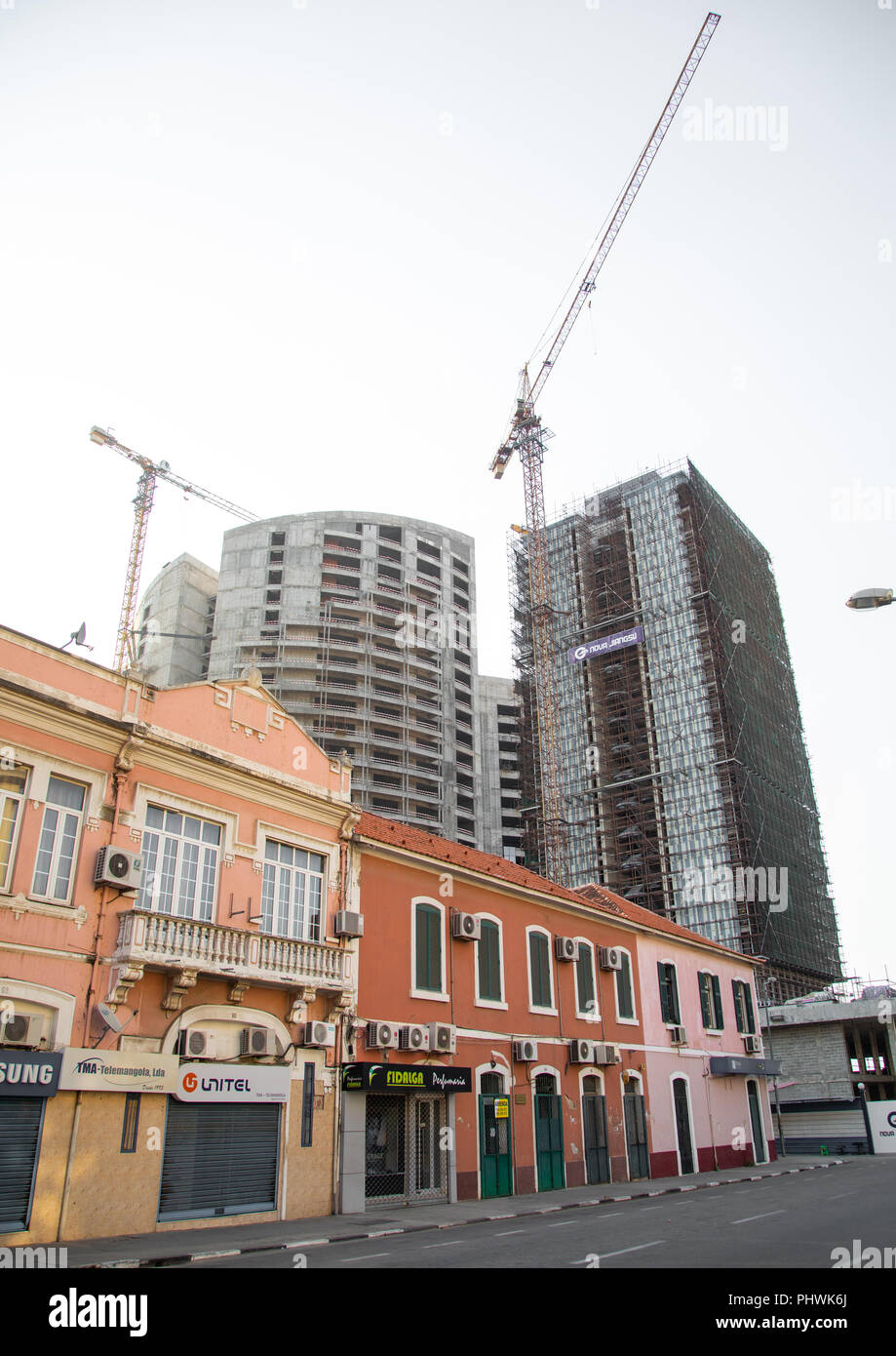 Old portuguese colonial building in front of a new skyscraper, Luanda ...