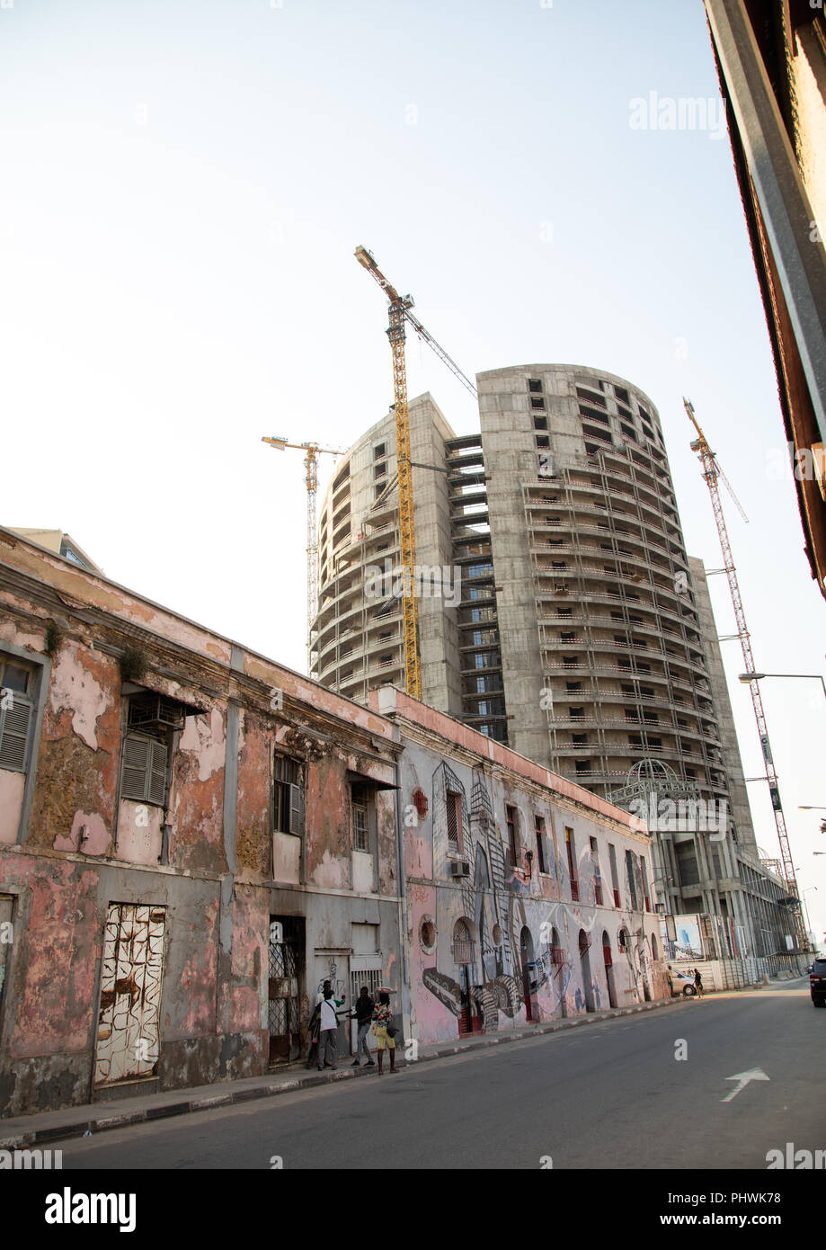 Old portuguese colonial building in front of a new skyscraper, Luanda ...