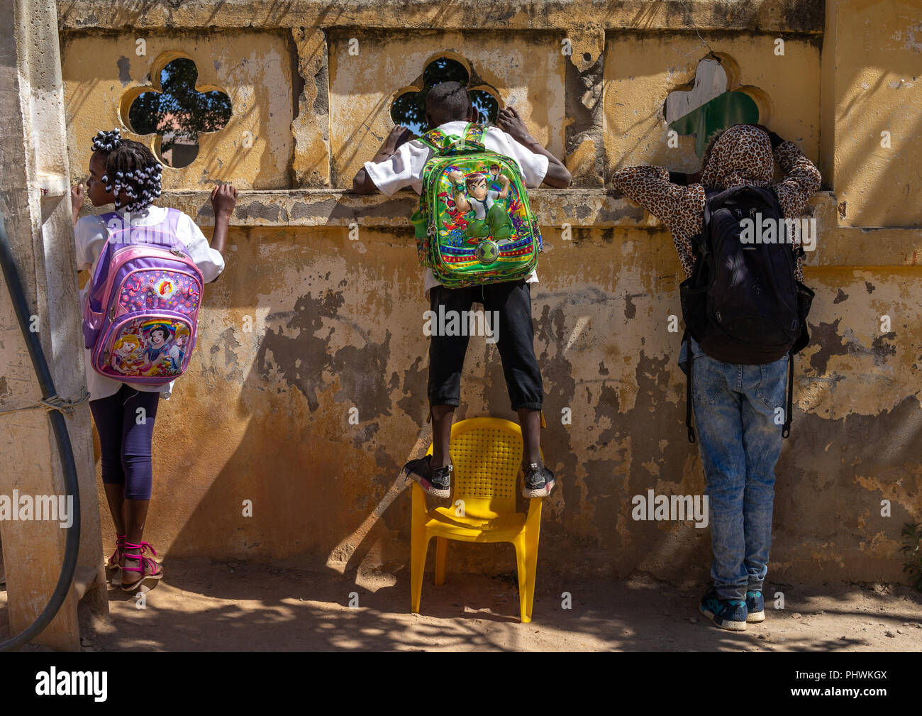 Angolan children looking inside their school from the street, Huila ...