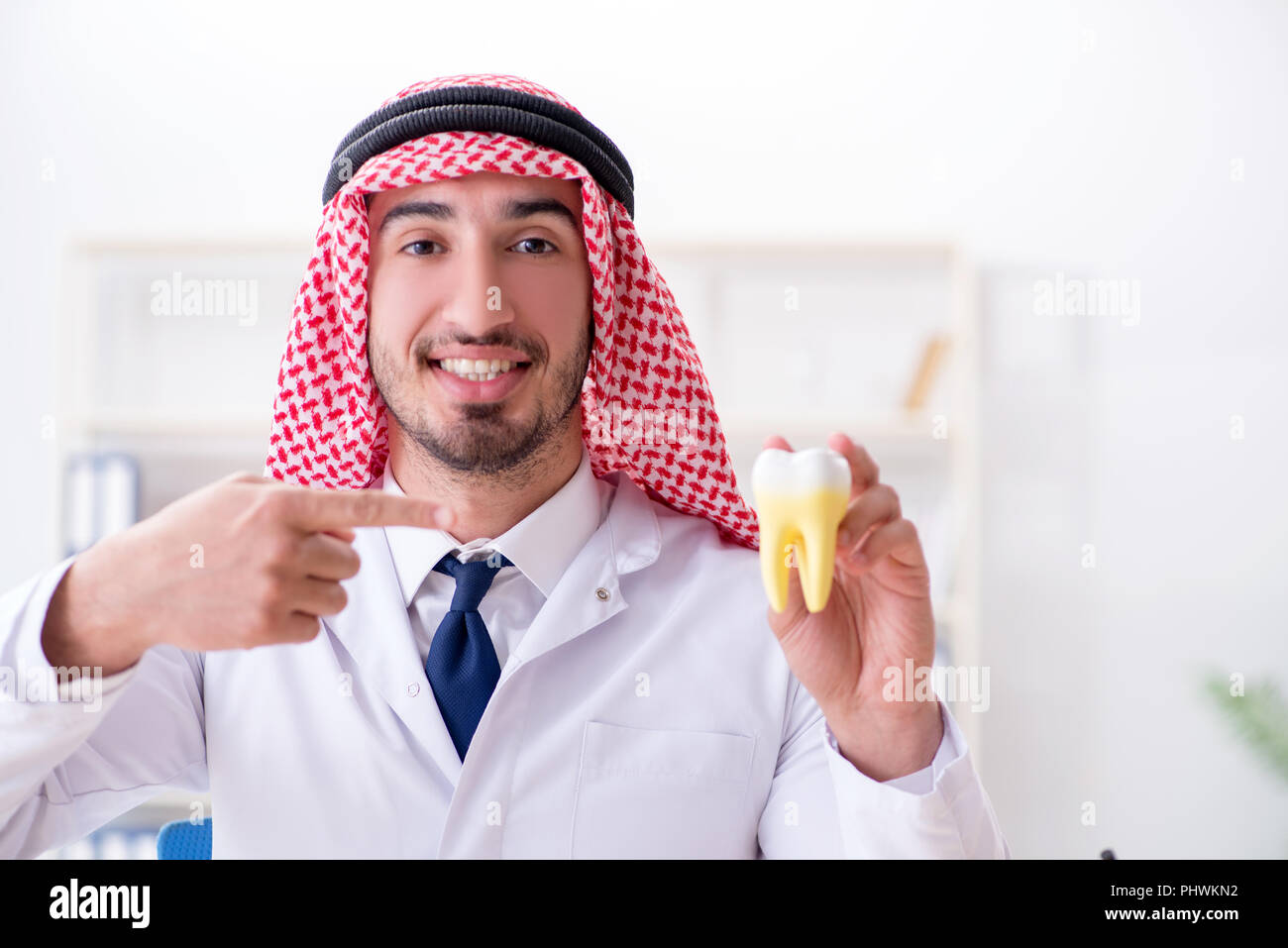 Arab dentist working on new teeth implant Stock Photo - Alamy