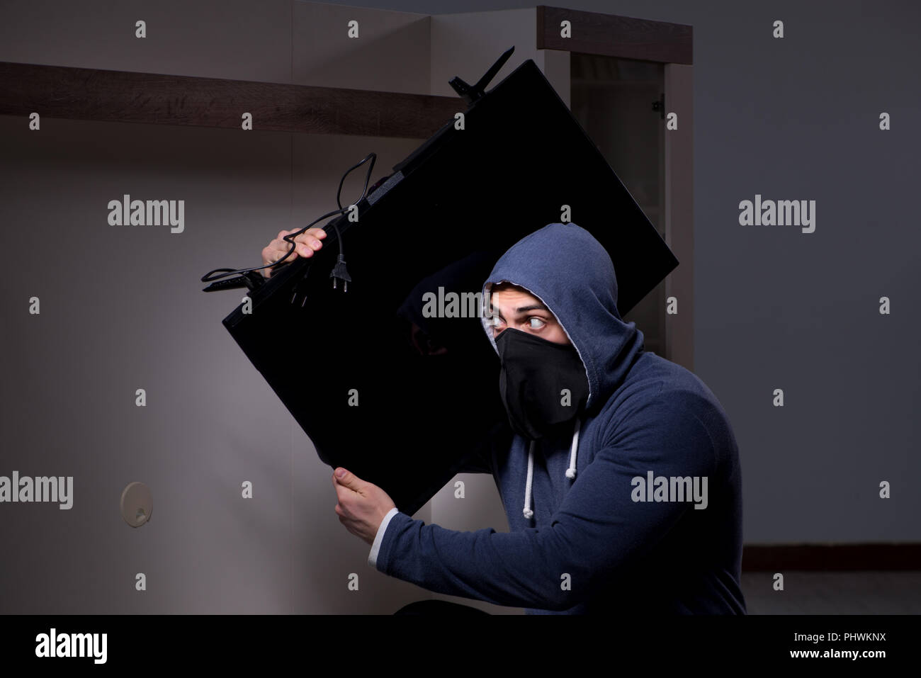 Burglar thief stealing tv from apartment house Stock Photo - Alamy