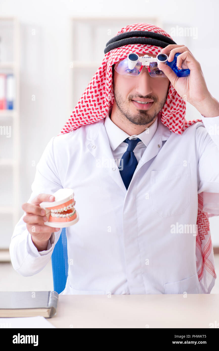 Arab dentist working on new teeth implant Stock Photo - Alamy