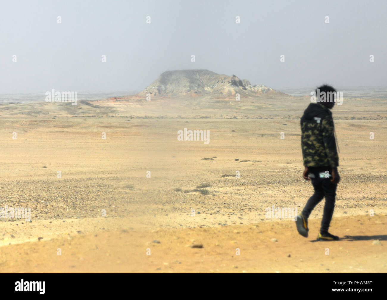 Angolan man walking in the desert, Cunene Province, Curoca, Angola ...