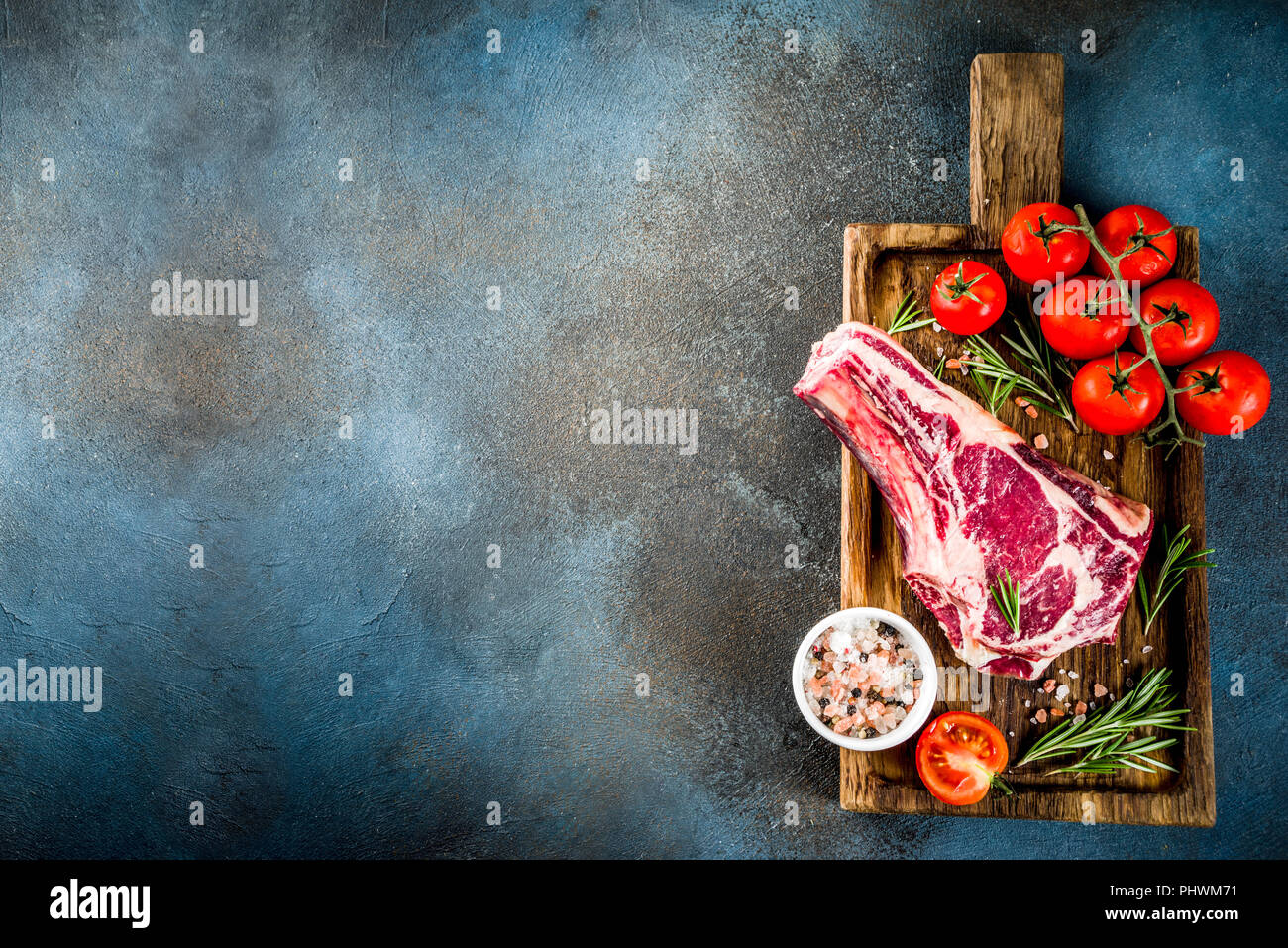 Raw rib eye beef steak meat with spices and ingredients for cooking ...