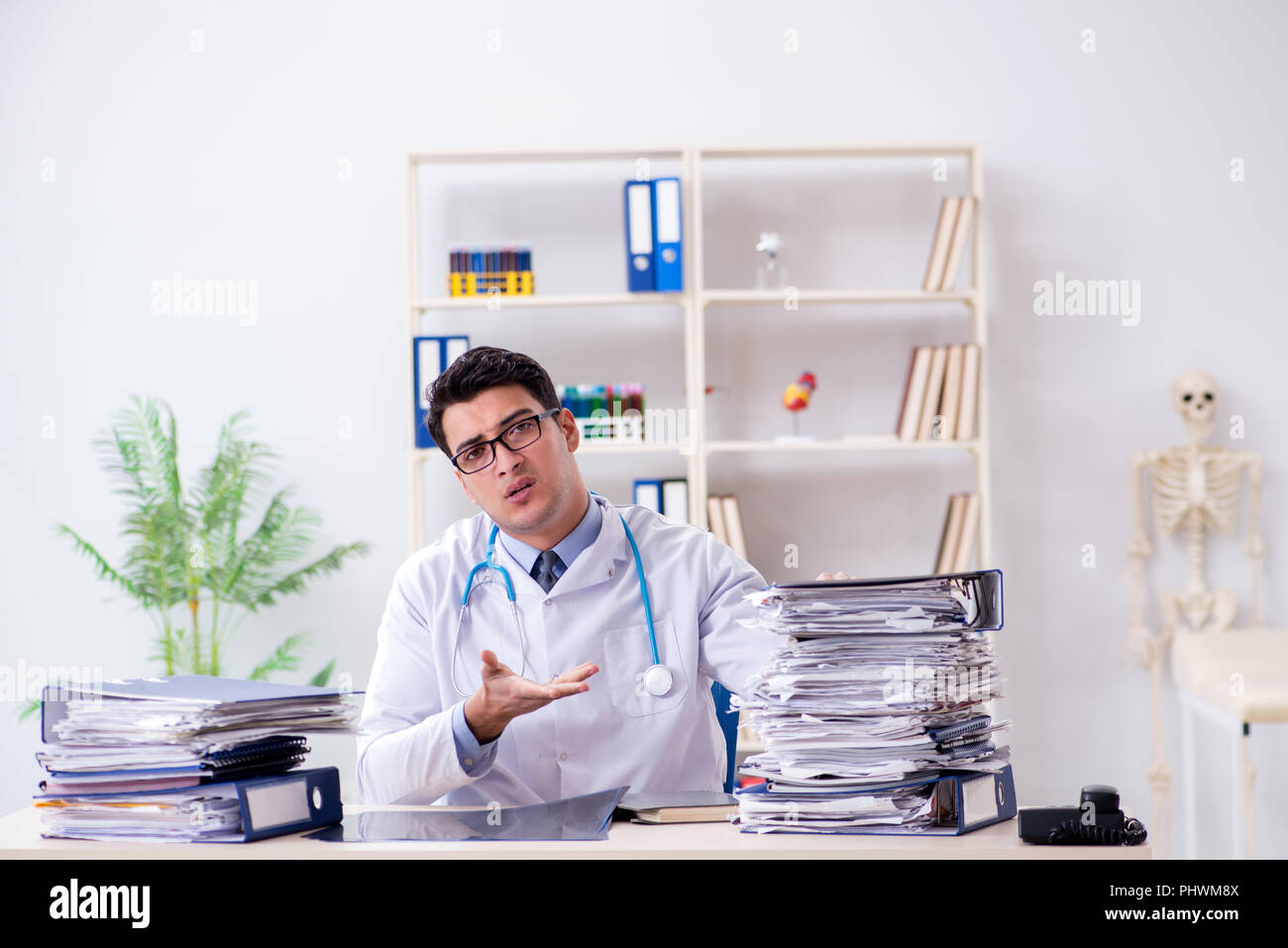 Busy doctor with too much work in hospital Stock Photo - Alamy