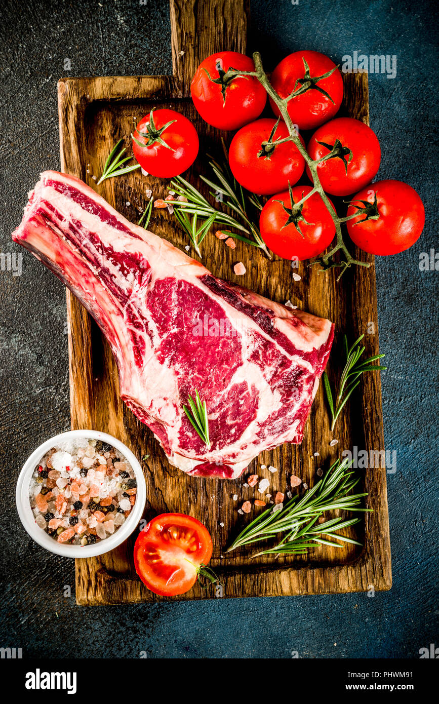 Raw rib eye beef steak meat with spices and ingredients for cooking ...