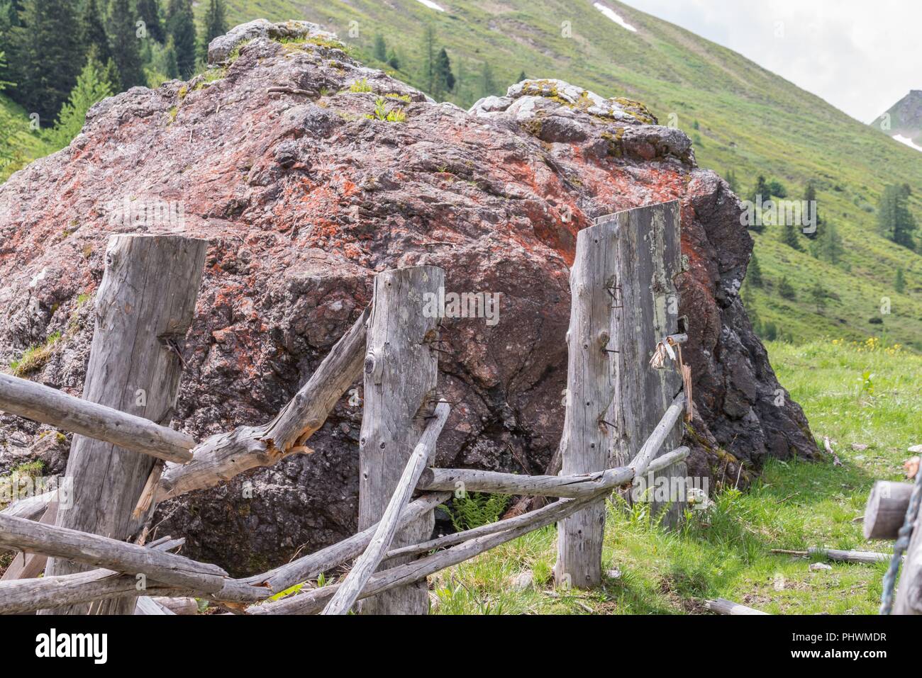 Giant stone boulder on a pasture and destroyed wooden fence, Austria ... Giant stone boulder on a pasture and destroyed wooden fence, Austria ...
