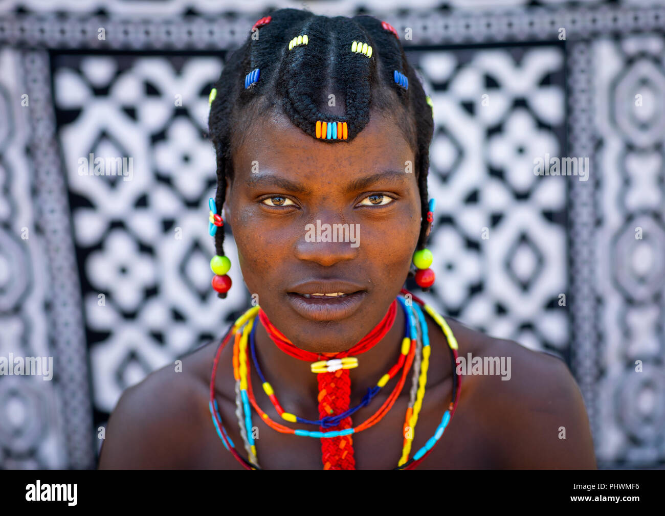 Portrait of a mudimba tribe woman in front of a printed cloth, Cunene ...