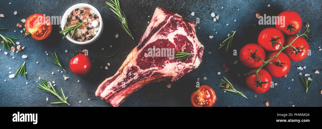 Raw rib eye beef steak meat with spices and ingredients for cooking ...