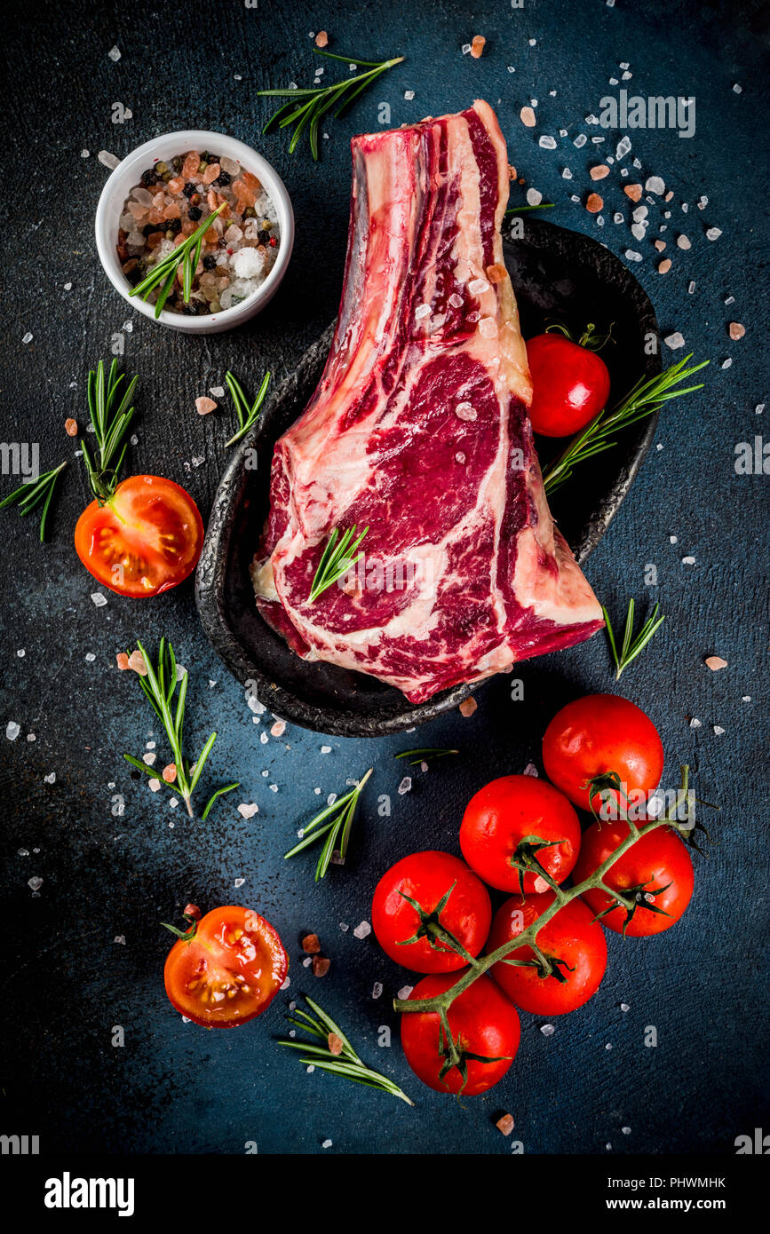 Raw rib eye beef steak meat with spices and ingredients for cooking ...