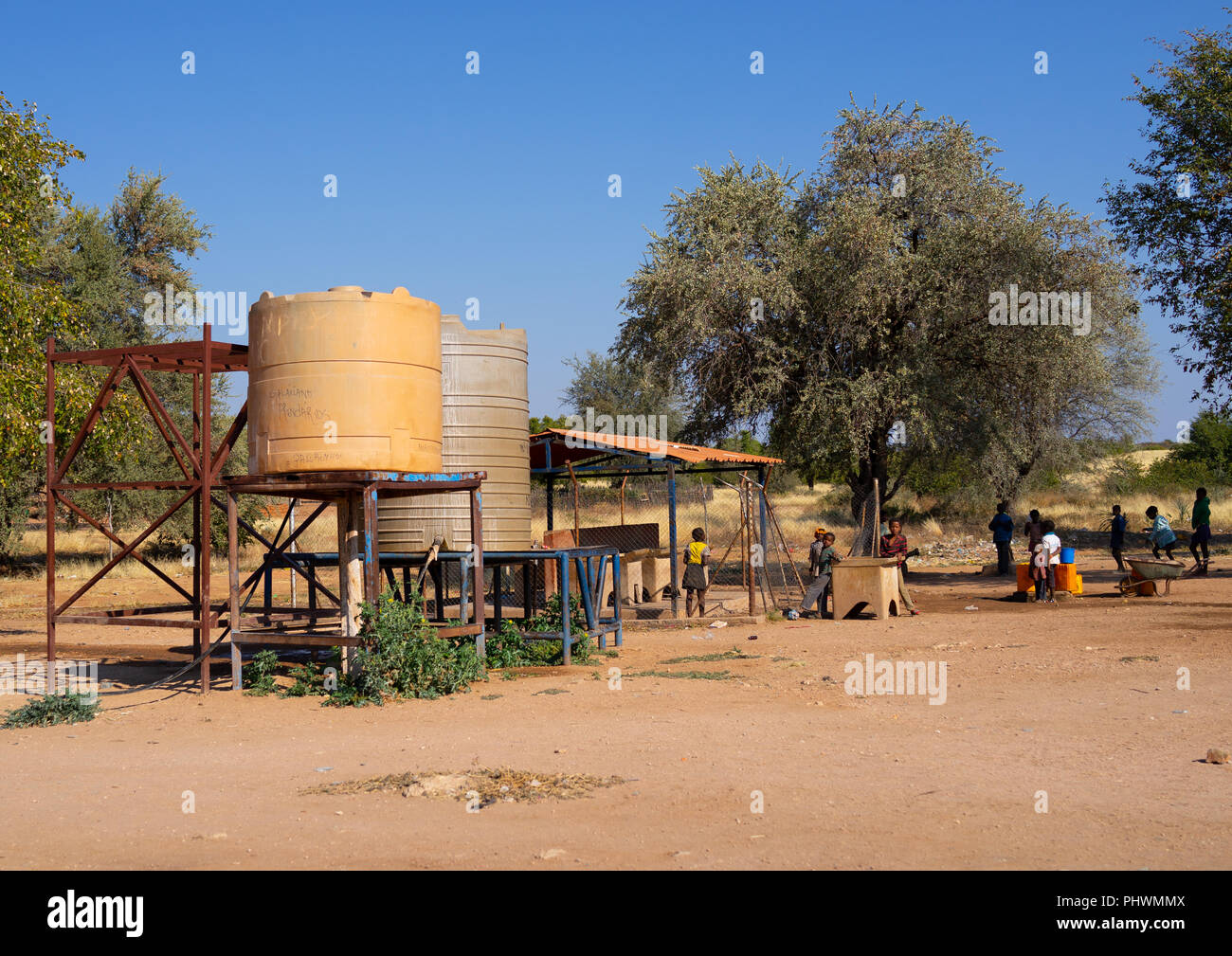Angolan children collecting water in a well, Cunene Province, Oncocua ...