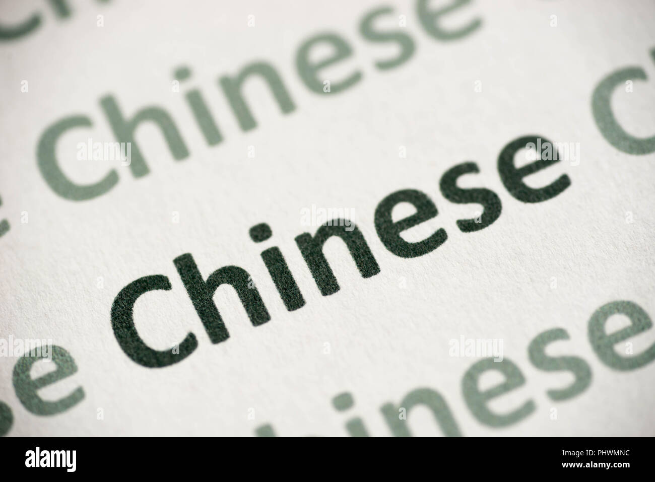 word Chinese language printed on white paper macro Stock Photo - Alamy