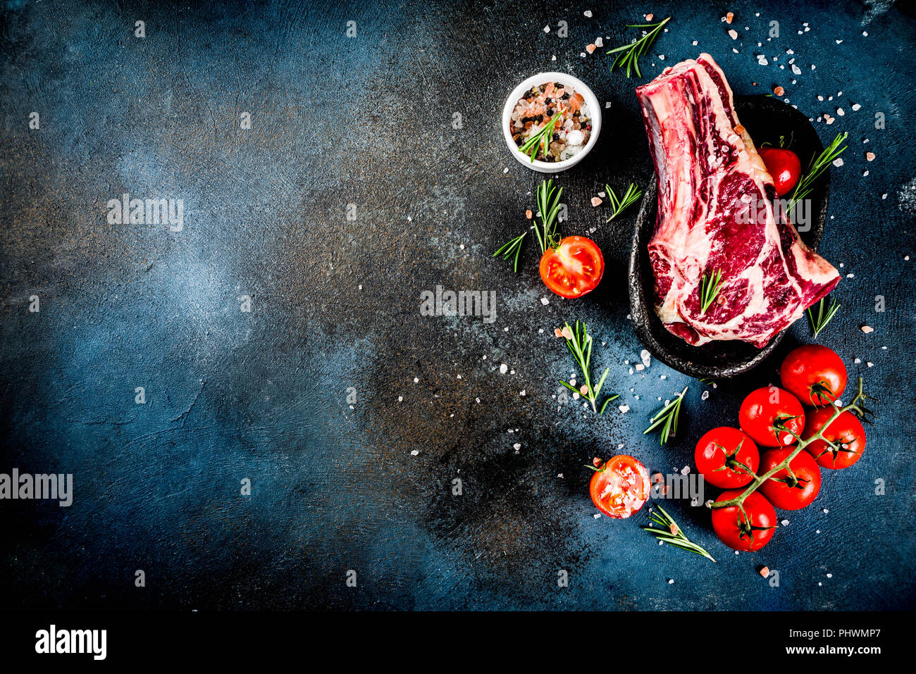 Raw rib eye beef steak meat with spices and ingredients for cooking ...