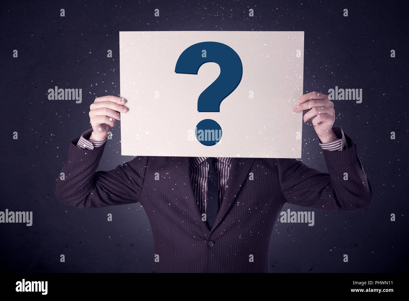 Young businessman hiding behind a question mark drawn on paper Stock ...
