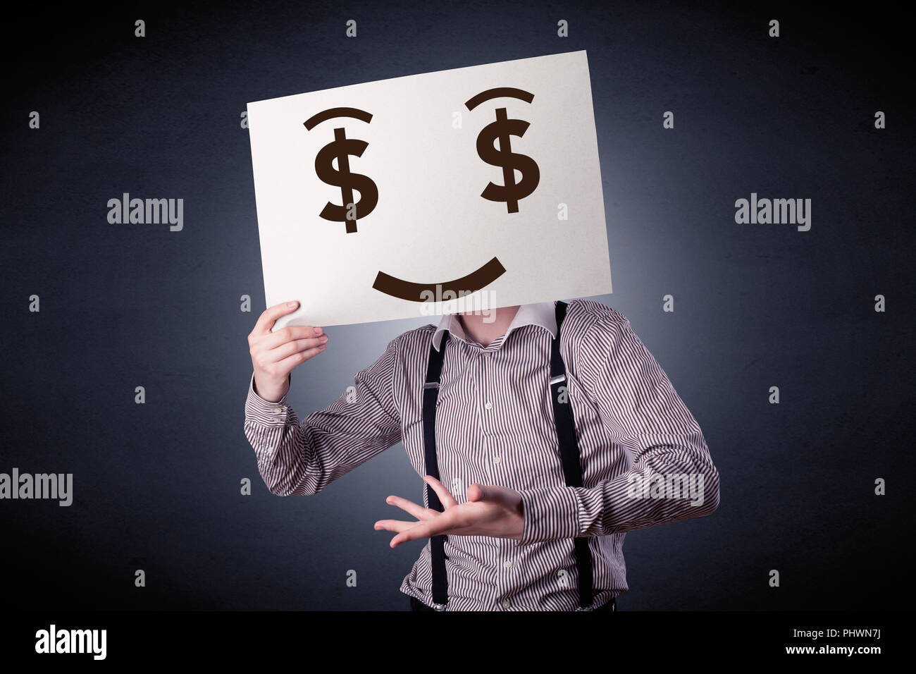 Young casual businessman hiding behind a greedy face drawing on ...