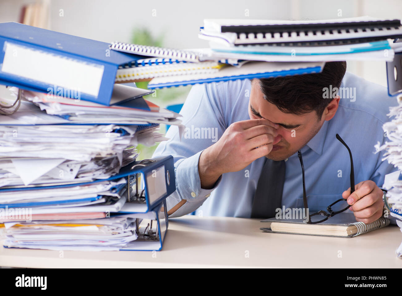 Extremely busy businessman working in office Stock Photo - Alamy