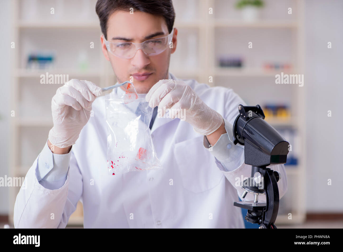 Expert criminologist working in the lab for evidence Stock Photo - Alamy