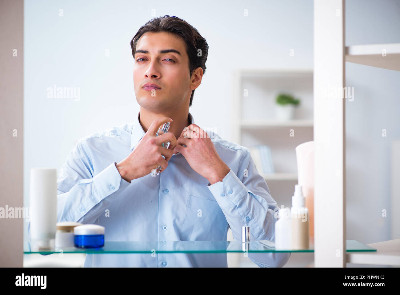 Man is getting dressed up for work in bathroom Stock Photo - Alamy