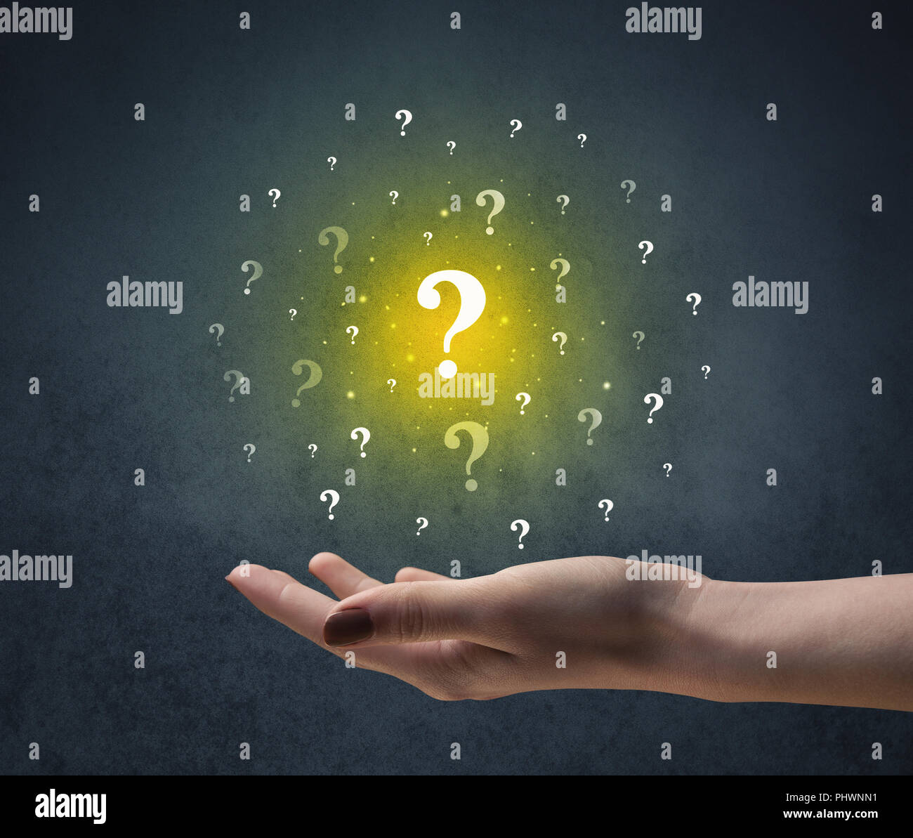Yellow question marks hovering over young hand Stock Photo - Alamy